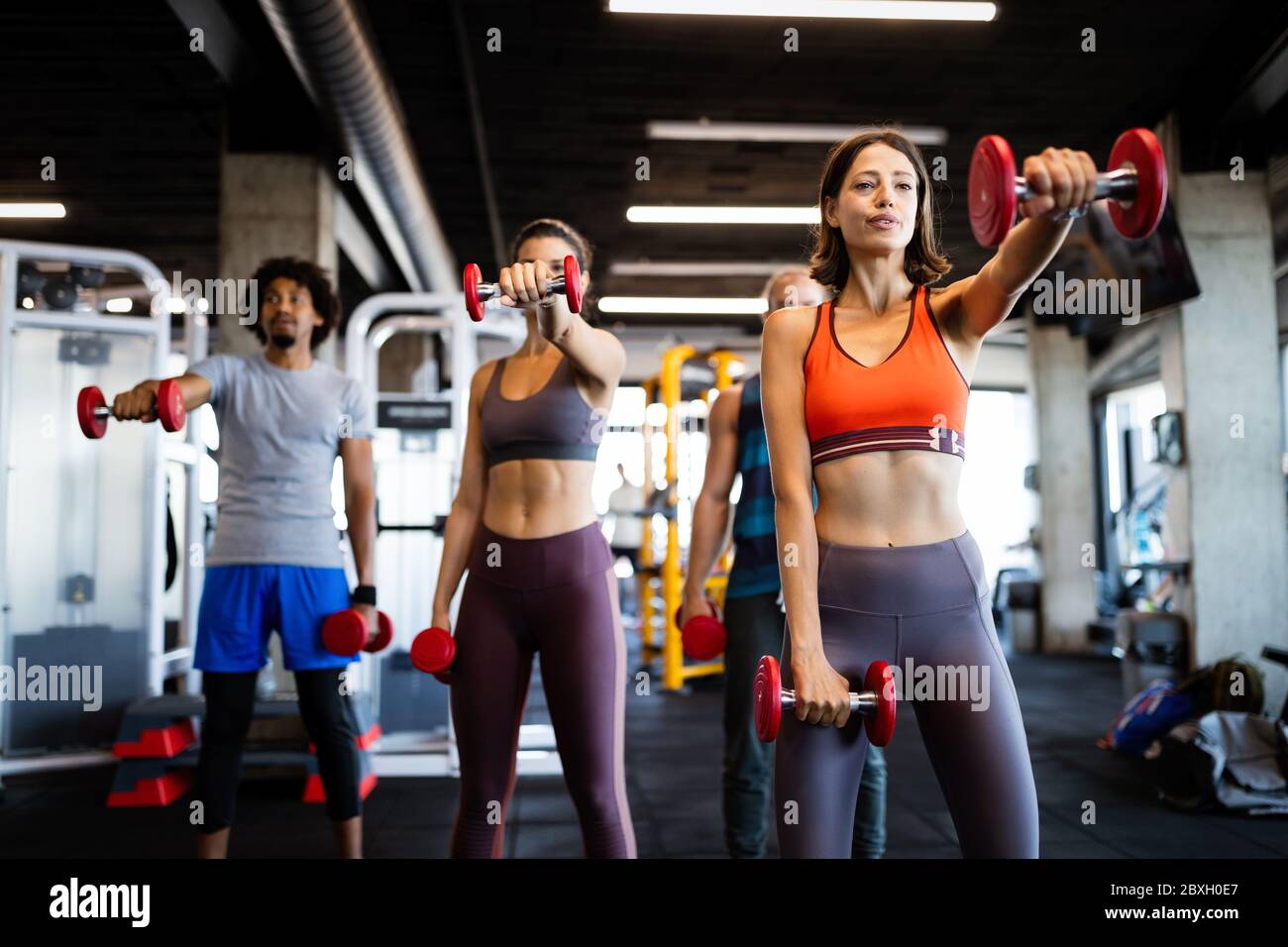 Beautiful fit people working out in gym together Stock Photo - Alamy