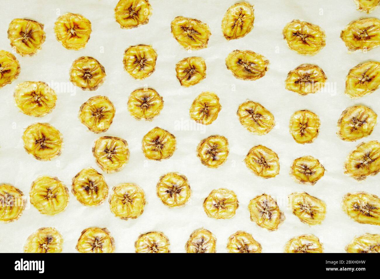 Banana chips, slices of fresh ripe bananas as food background. cooking ...