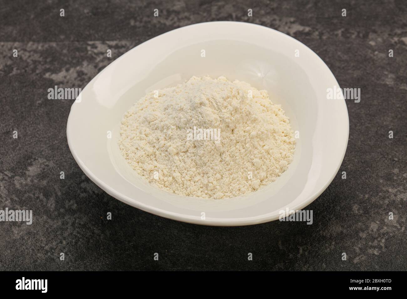 Wheat flour heap in the bowl for cooking Stock Photo - Alamy