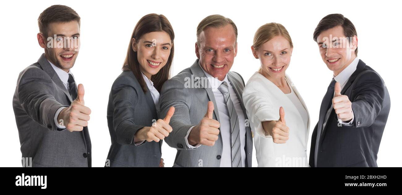 Successful smiling business team with thumbs up isolated over a white ...