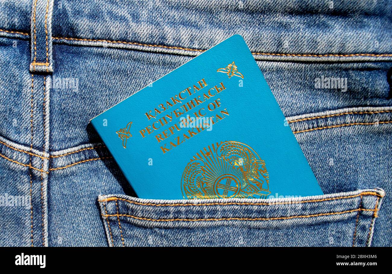 Kazakhstan passport close up in a blue jeans back pocket. KZ passport ...
