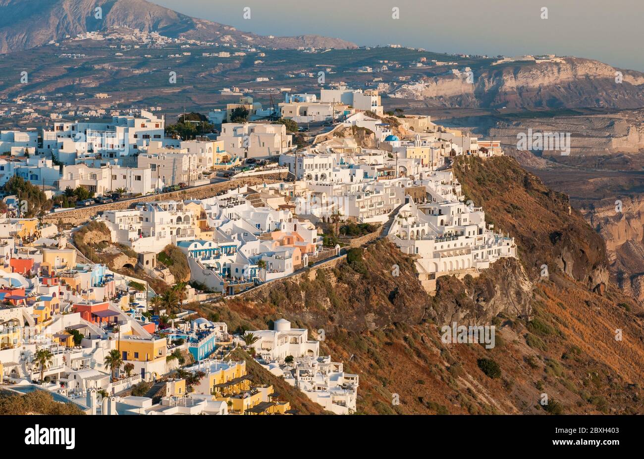 Cityscape of Fira town with white houses and the caldera in Santorini ...