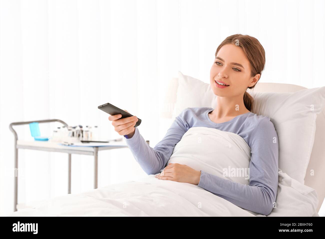 Hospital patient watching tv in bed hi-res stock photography and images ...