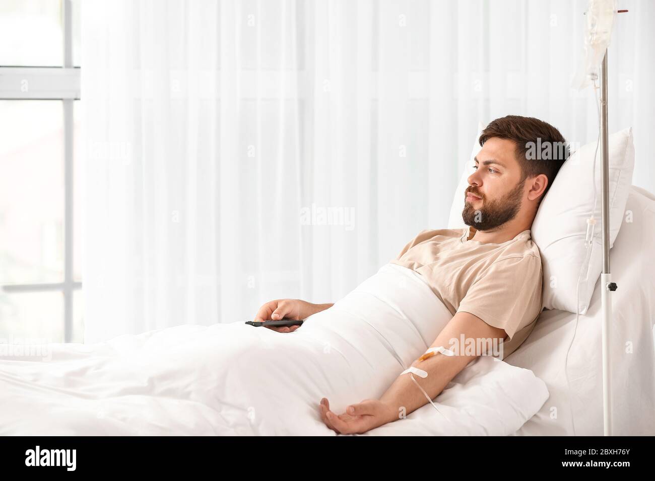 Hospital patient watching tv in bed hi-res stock photography and images ...