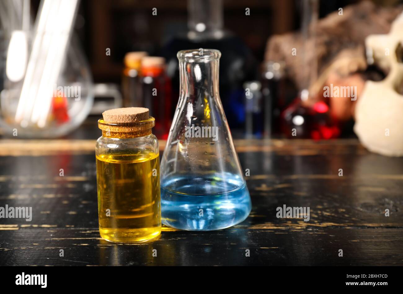 Bottles with potions on alchemist's table Stock Photo - Alamy