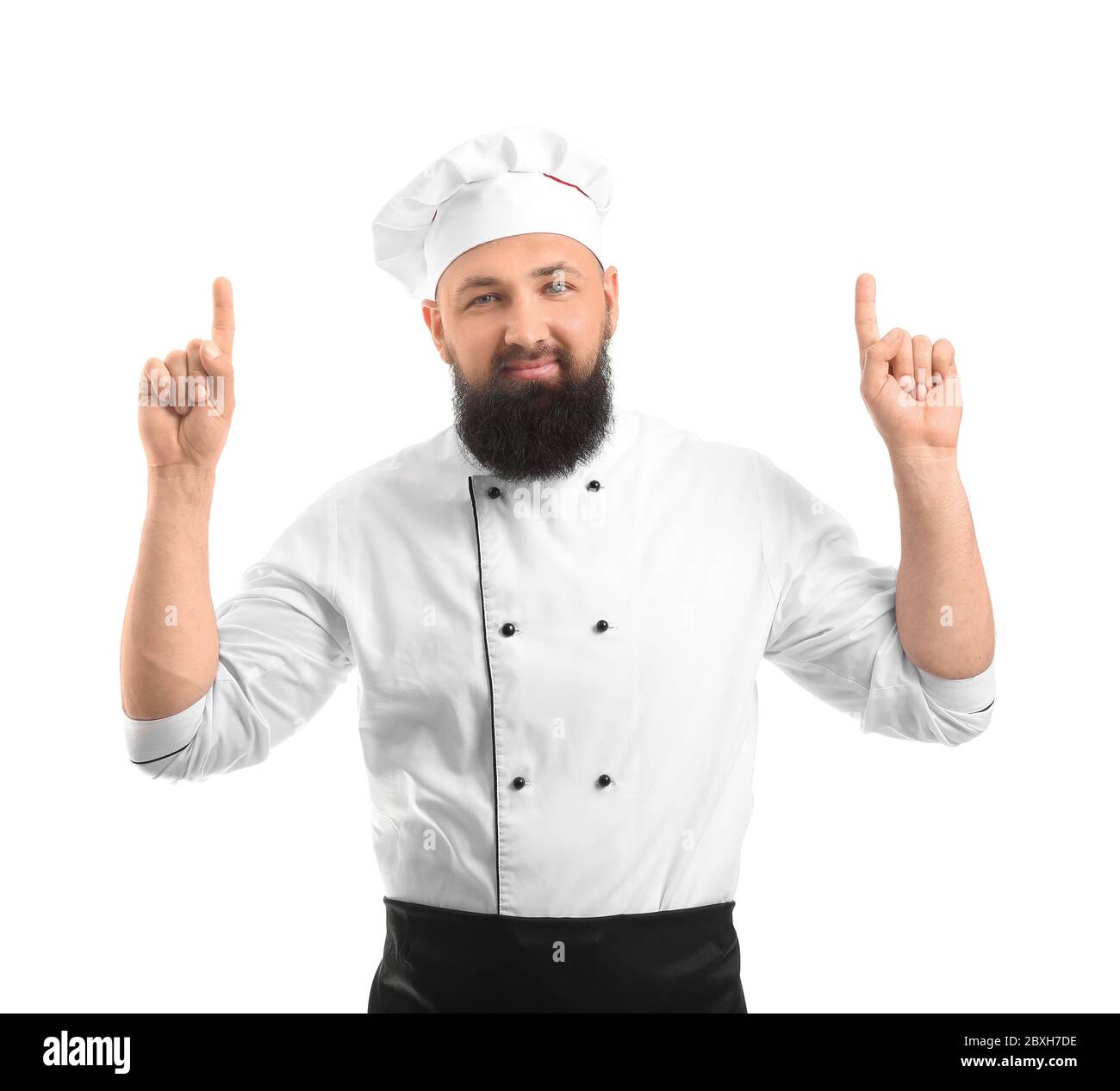 Handsome male chef pointing at something on white background Stock ...