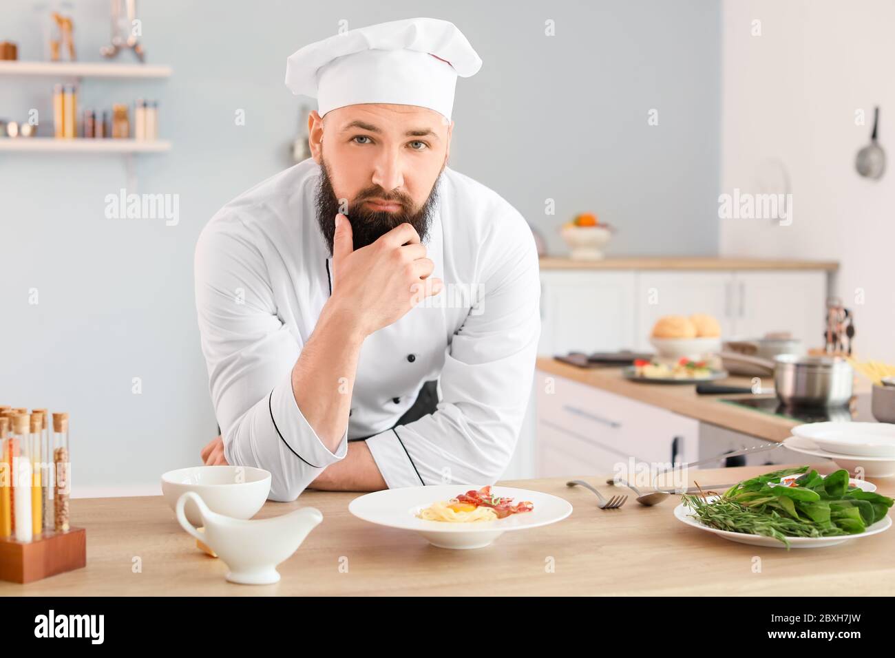 Portrait of handsome male chef in kitchen Stock Photo - Alamy