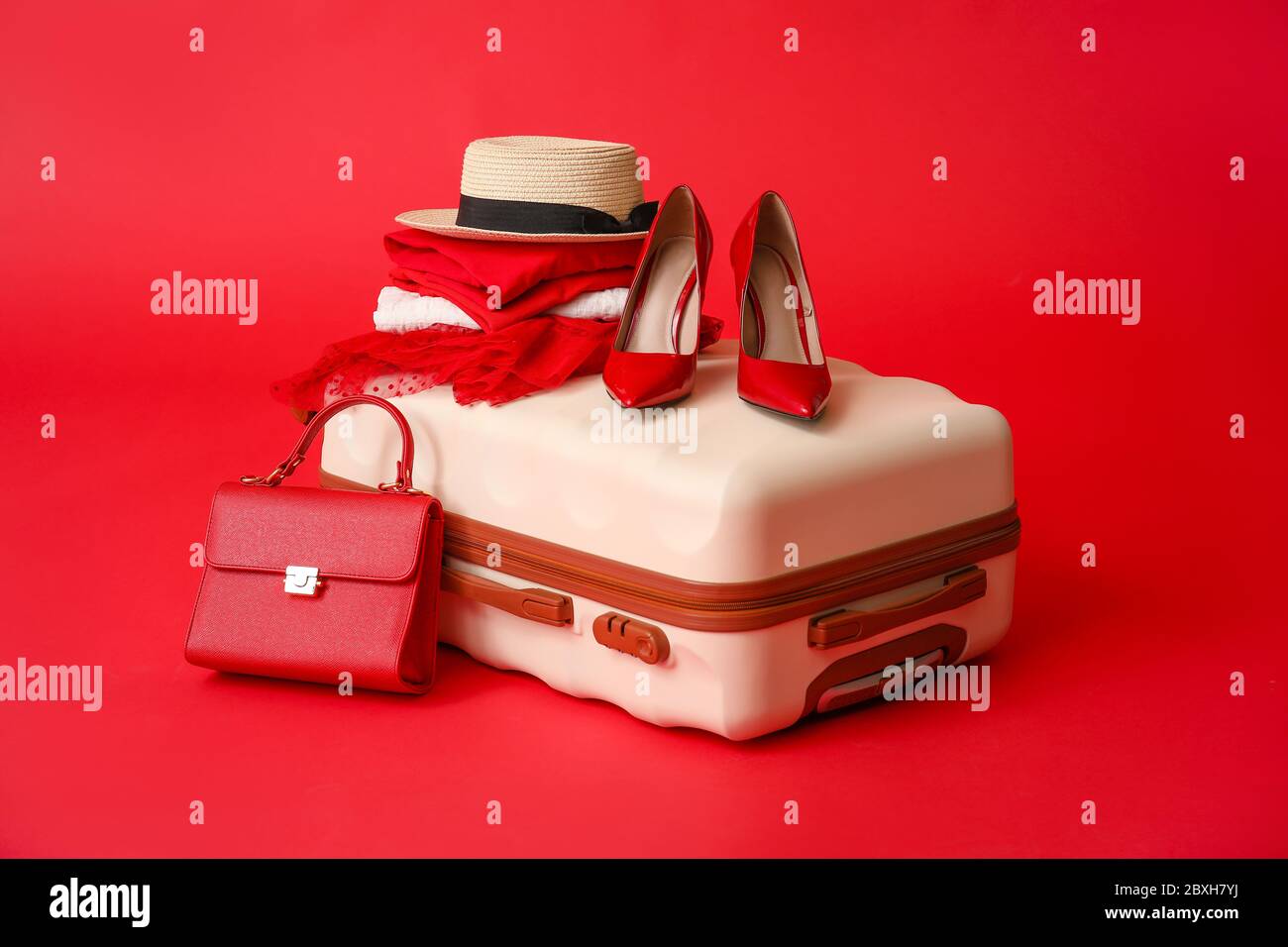 Packed suitcase and accessories on color background Stock Photo - Alamy