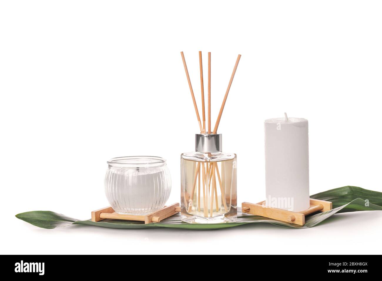 Reed diffuser and candles on white background Stock Photo - Alamy