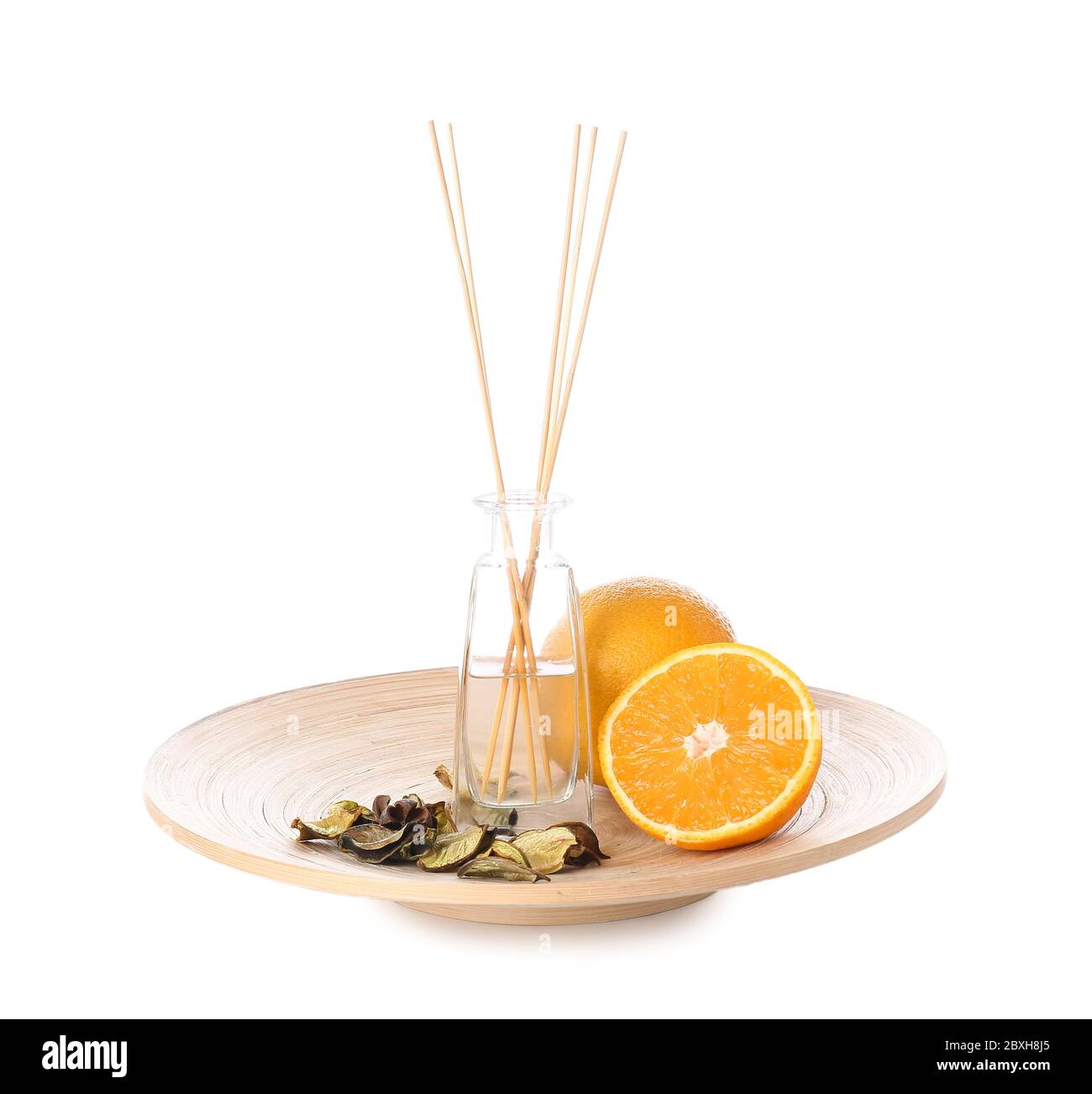 Reed diffuser and orange on white background Stock Photo - Alamy