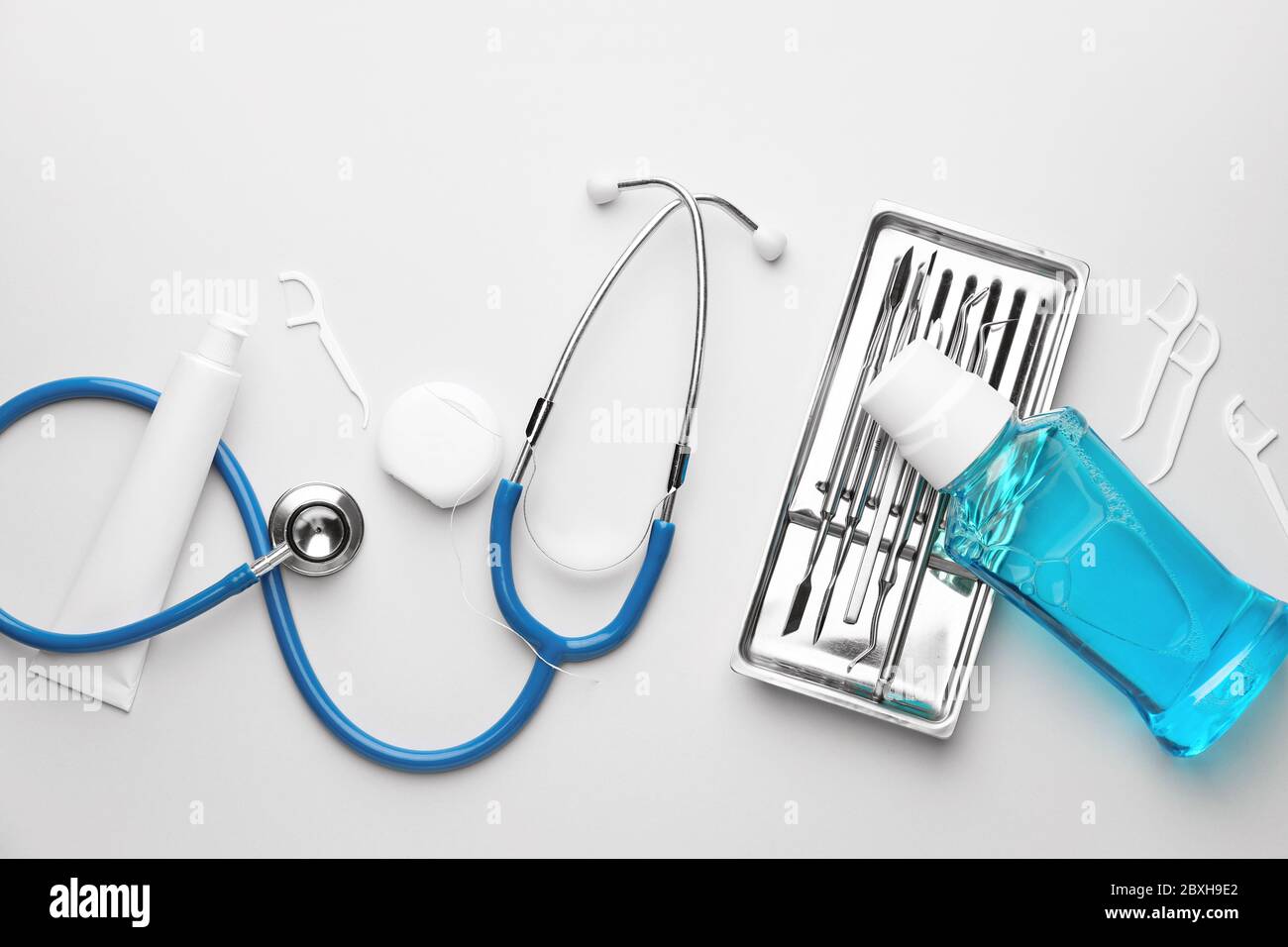 Set for oral hygiene with stethoscope and dental tools on white ...