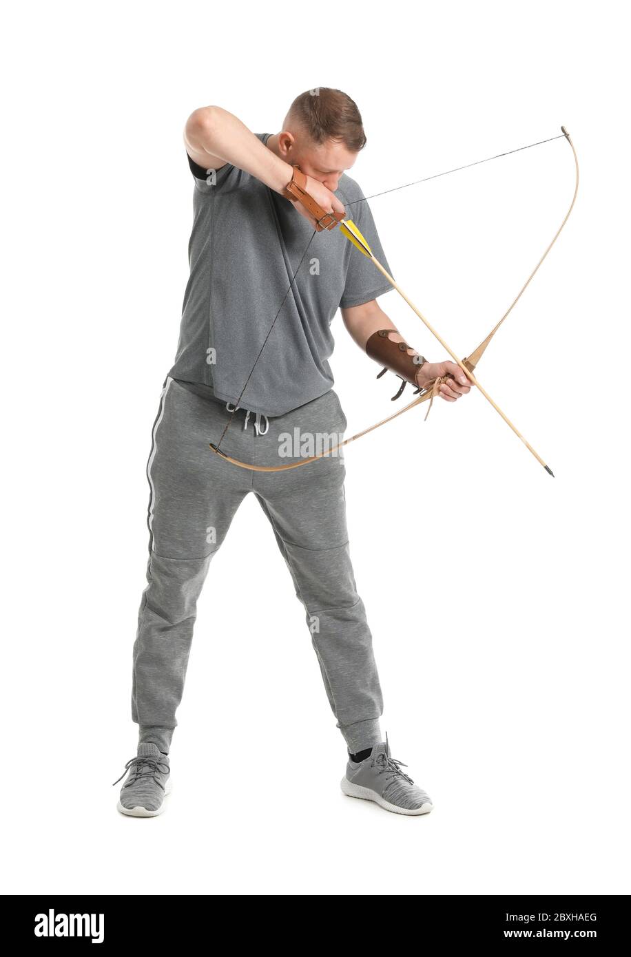 Handsome male archer with bow on white background Stock Photo - Alamy