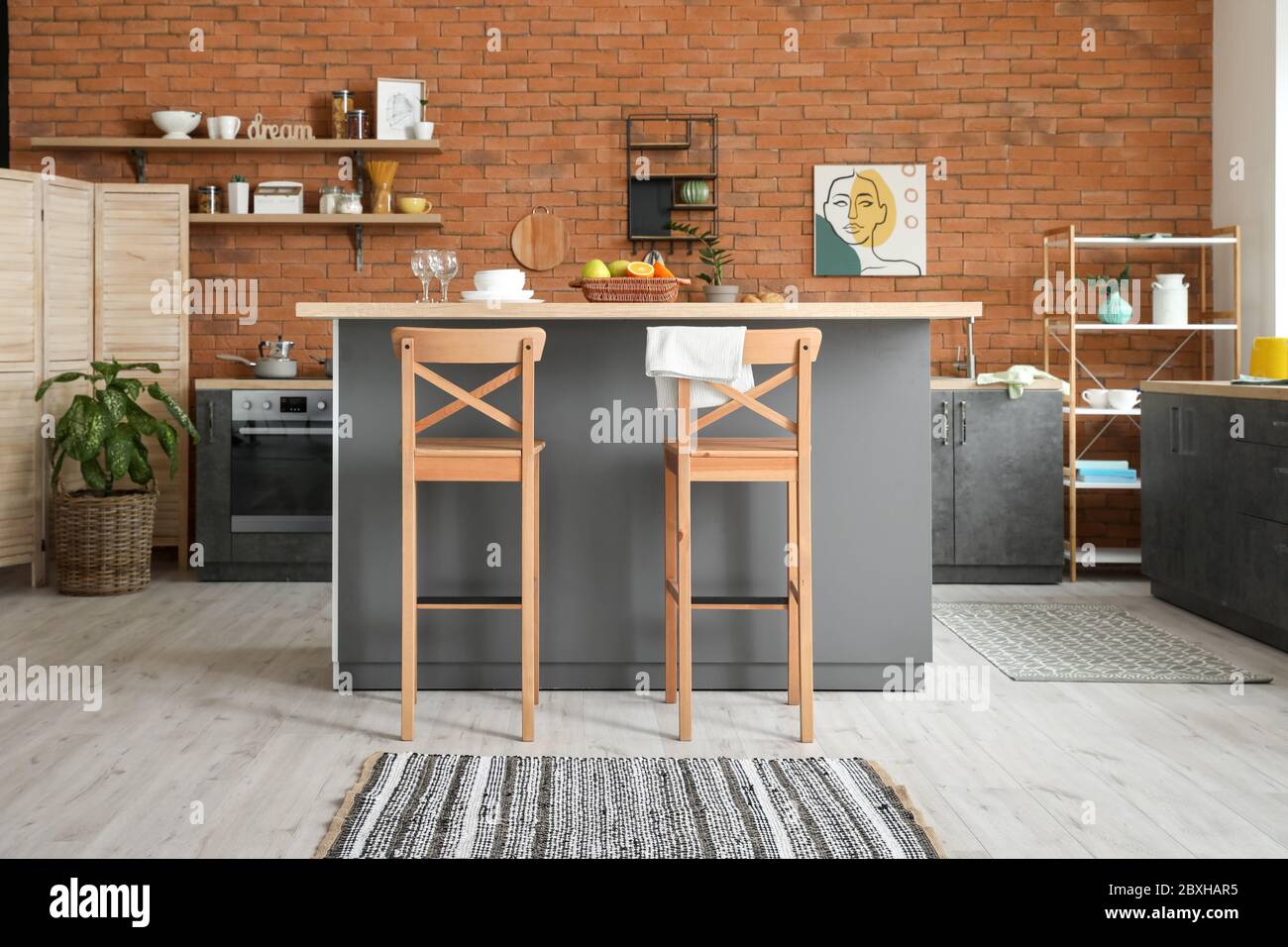 Interior of modern kitchen with stylish table Stock Photo - Alamy