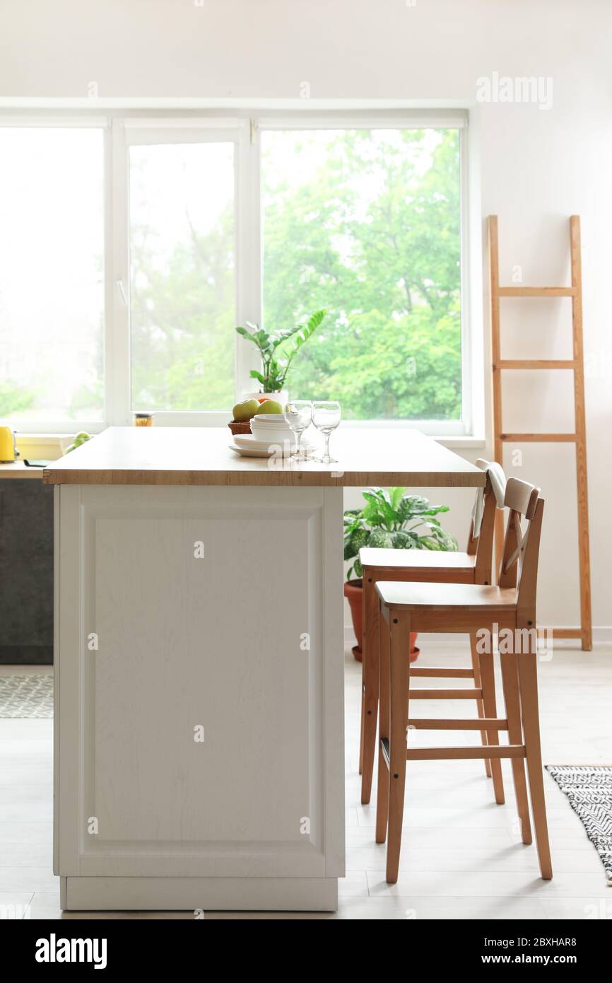 Interior of modern kitchen with stylish table Stock Photo - Alamy