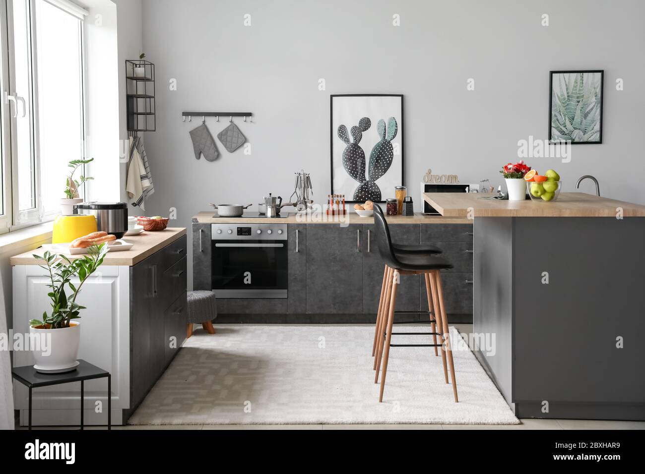 Interior of modern kitchen with stylish table Stock Photo - Alamy