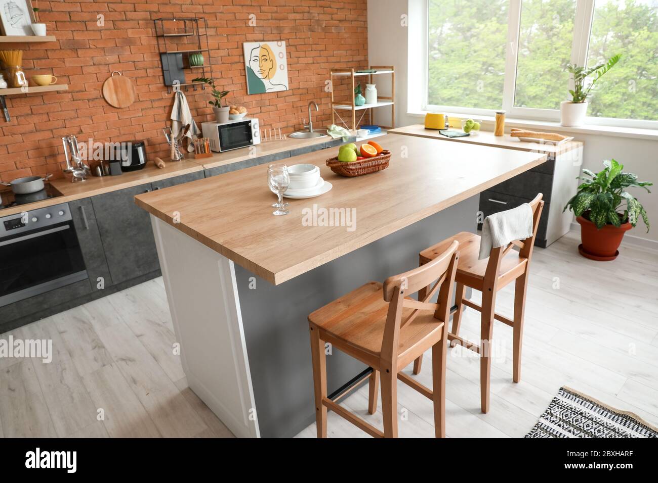 Interior of modern kitchen with stylish table Stock Photo - Alamy