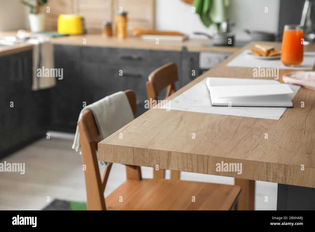 Stylish table in modern kitchen Stock Photo - Alamy
