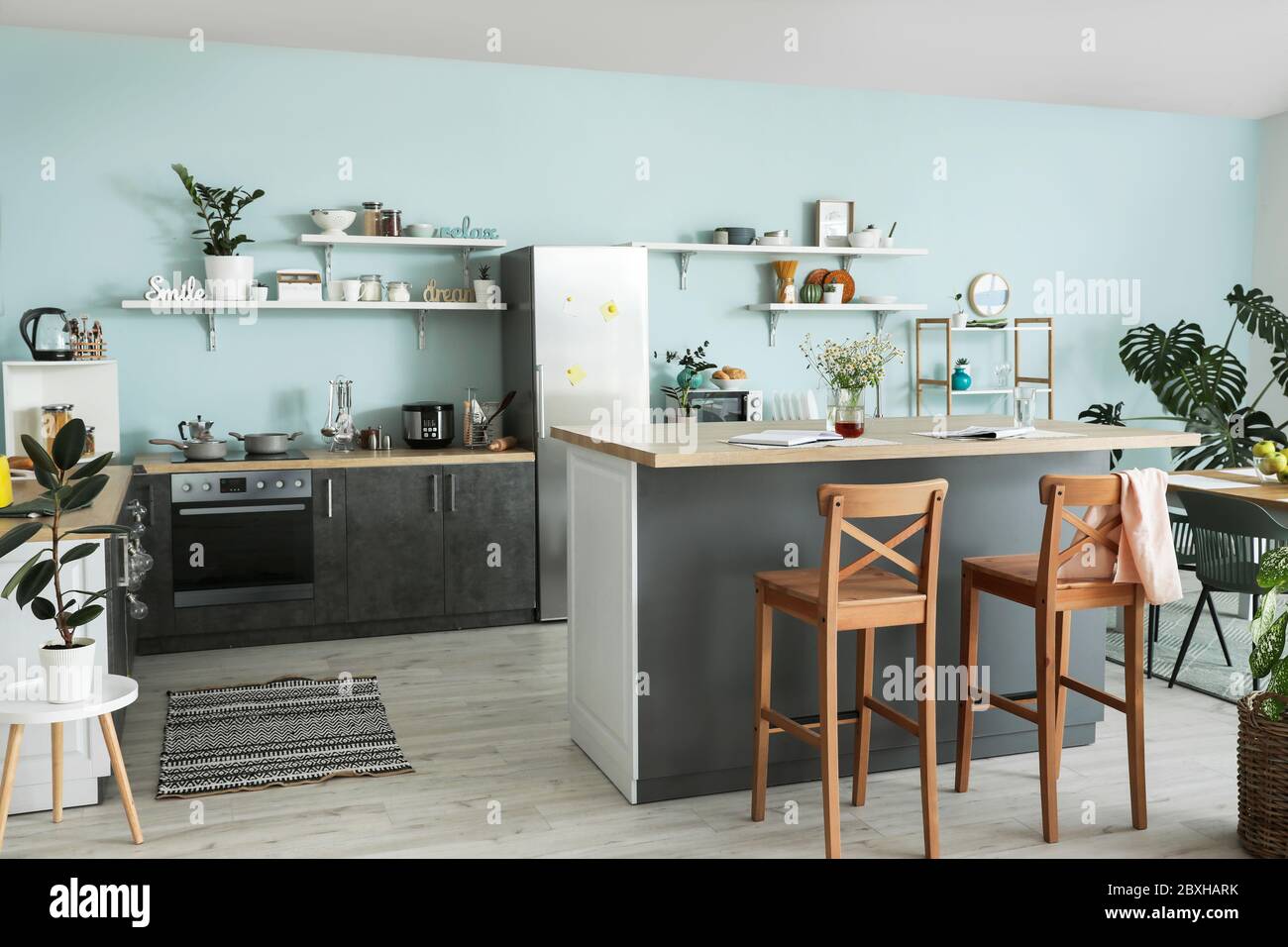 Interior of modern kitchen with stylish table Stock Photo - Alamy