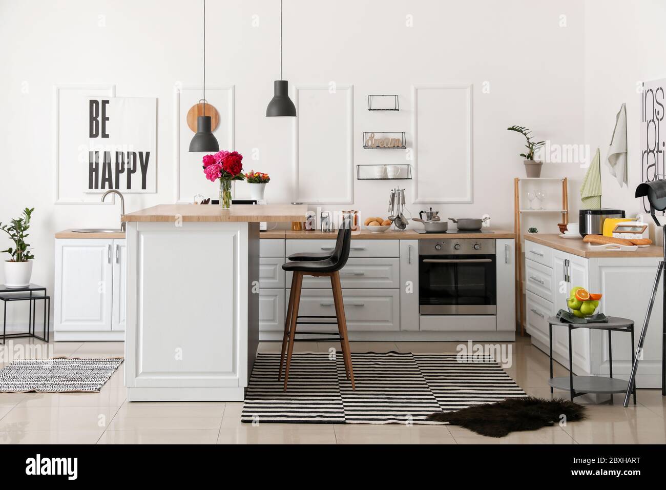 Interior of modern kitchen with stylish table Stock Photo - Alamy