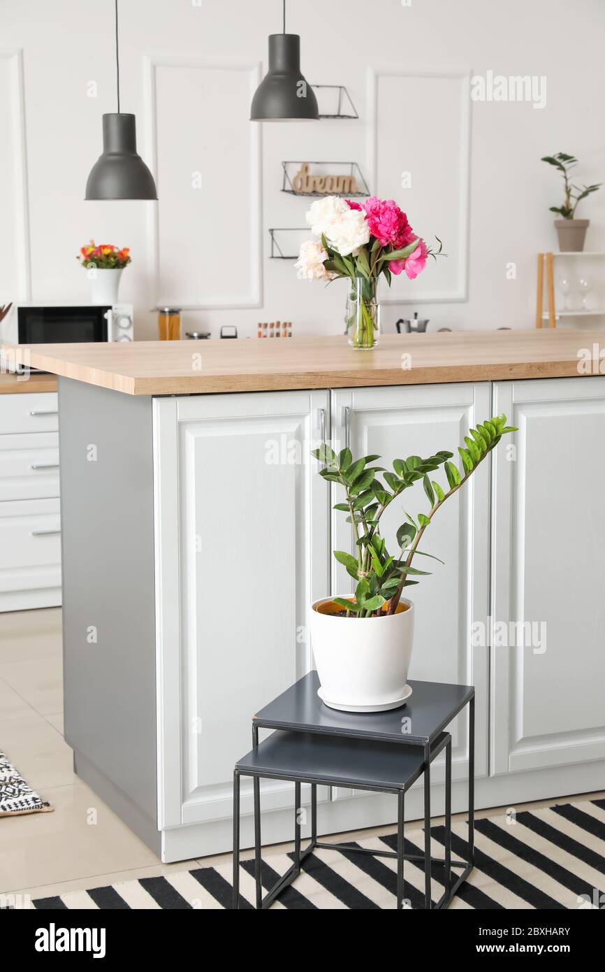 Interior of modern kitchen with stylish table Stock Photo - Alamy