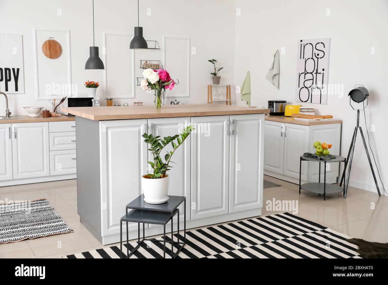 Interior of modern kitchen with stylish table Stock Photo - Alamy