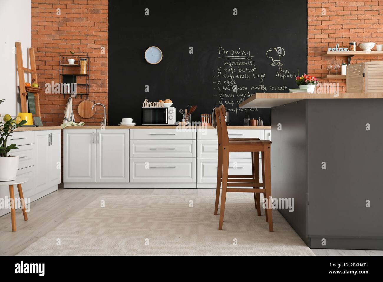 Interior of modern kitchen with stylish table Stock Photo - Alamy