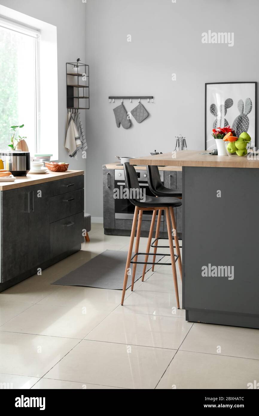 Interior of modern kitchen with stylish table Stock Photo - Alamy