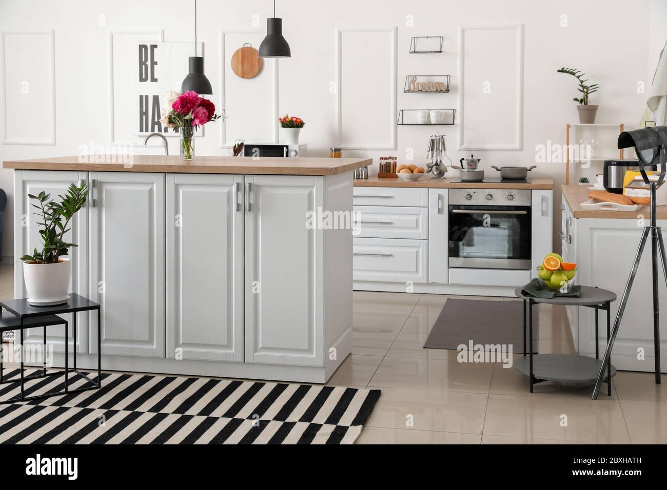 Interior of modern kitchen with stylish table Stock Photo - Alamy