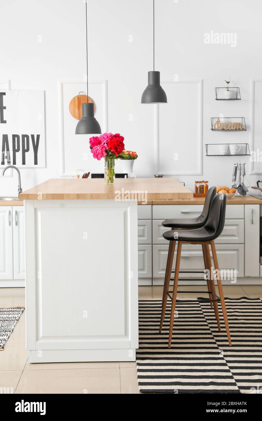 Interior of modern kitchen with stylish table Stock Photo - Alamy