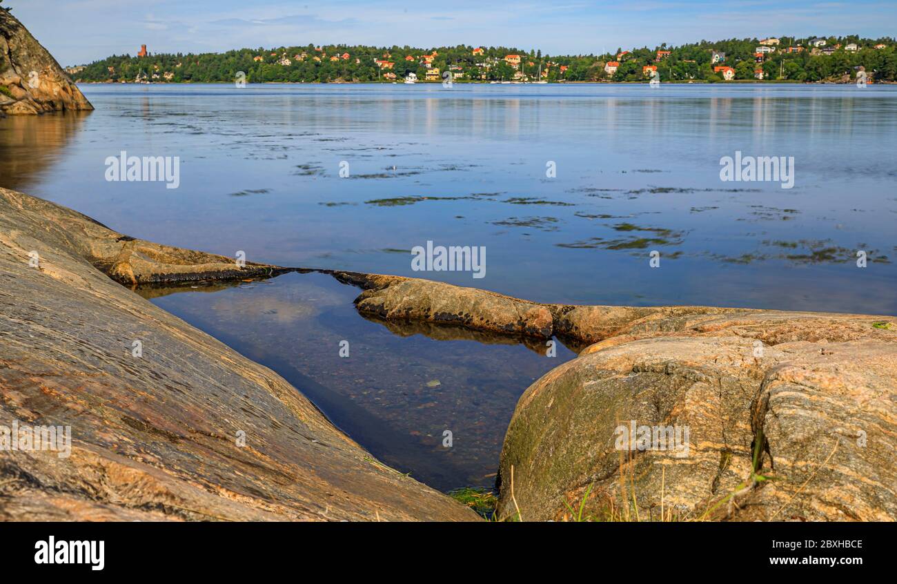 View across Lilla Vartan strait onto the shoreline of Stockholm suburbs ...