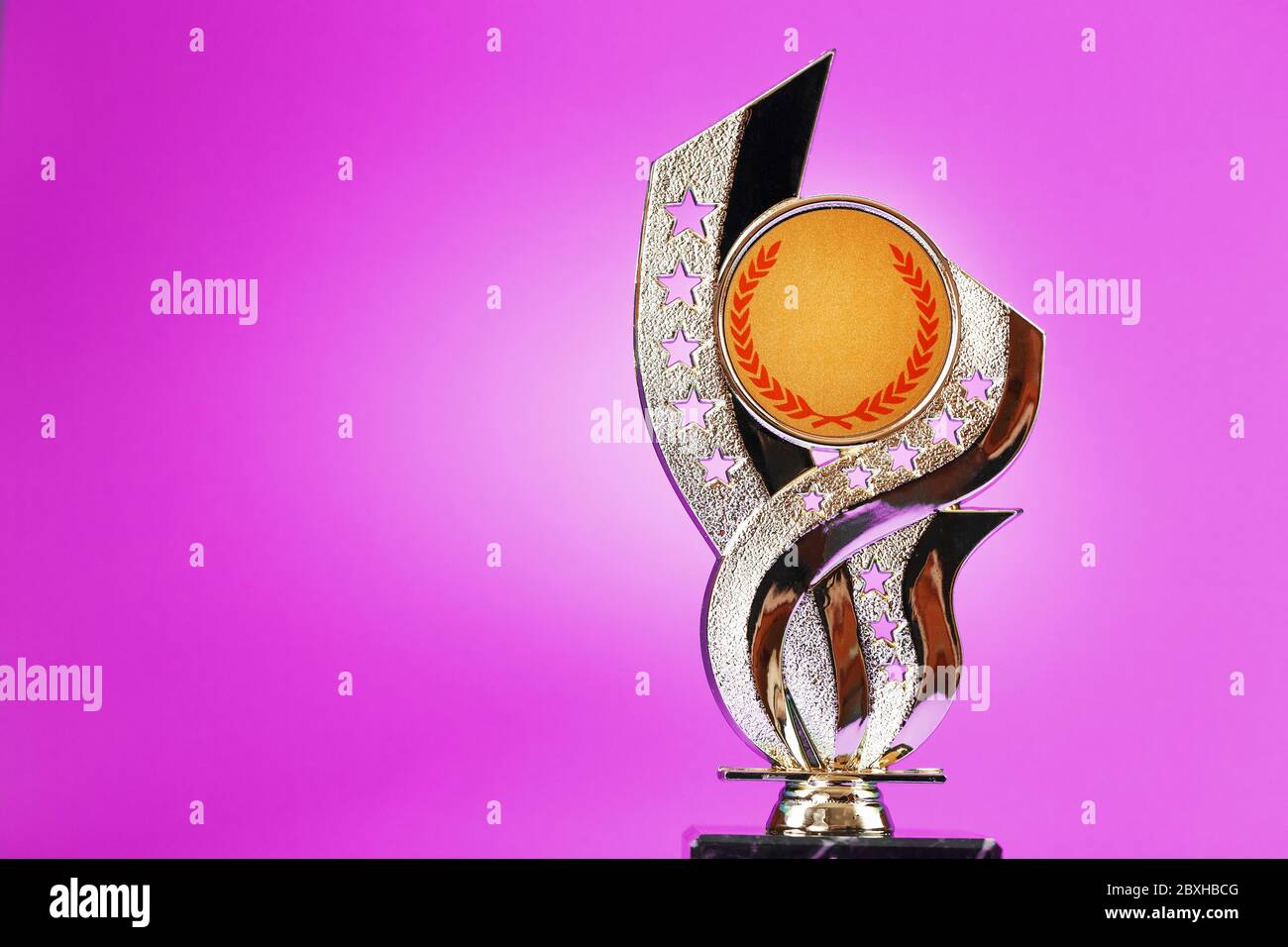 Superprize statuette made of gold on a pink background Stock Photo - Alamy