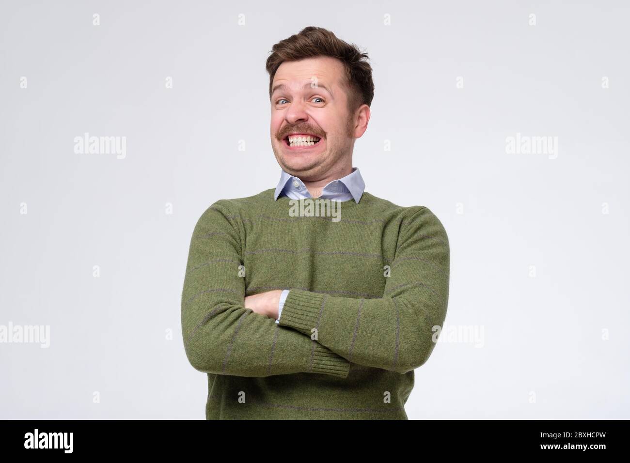 Smart funny young man smiling standing against white background Stock ...