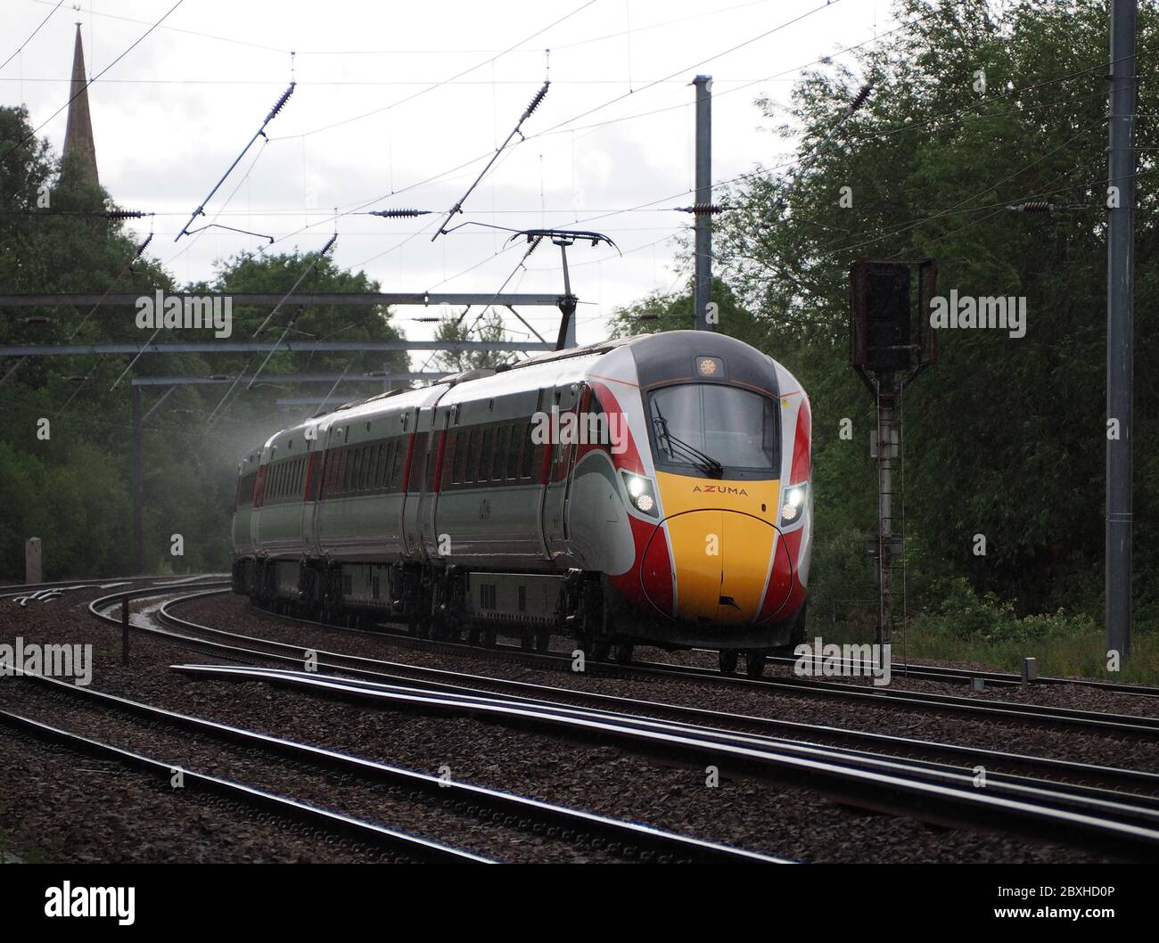 LNER Class 800 Azuma passes Offord Cluny in the rain on the East Coast Main Line, Cambridgeshire ...