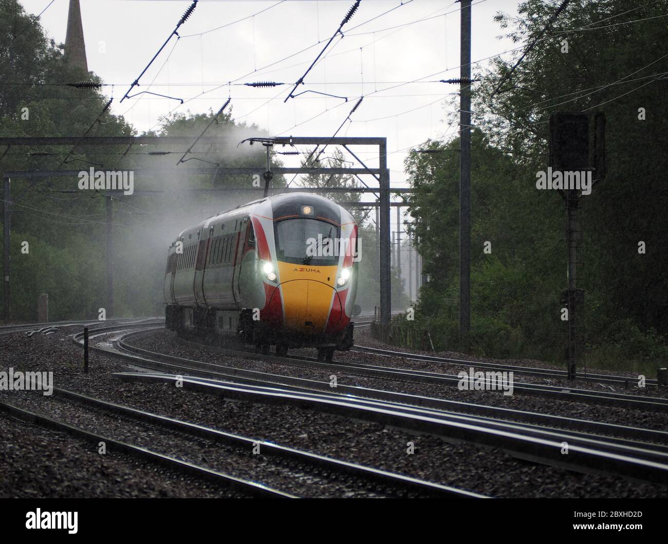 LNER Class 800 Azuma passes Offord Cluny in the rain on the East Coast ...