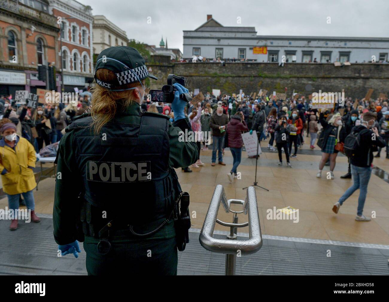 A female PSNI officer films protestors during a Justice for George ...