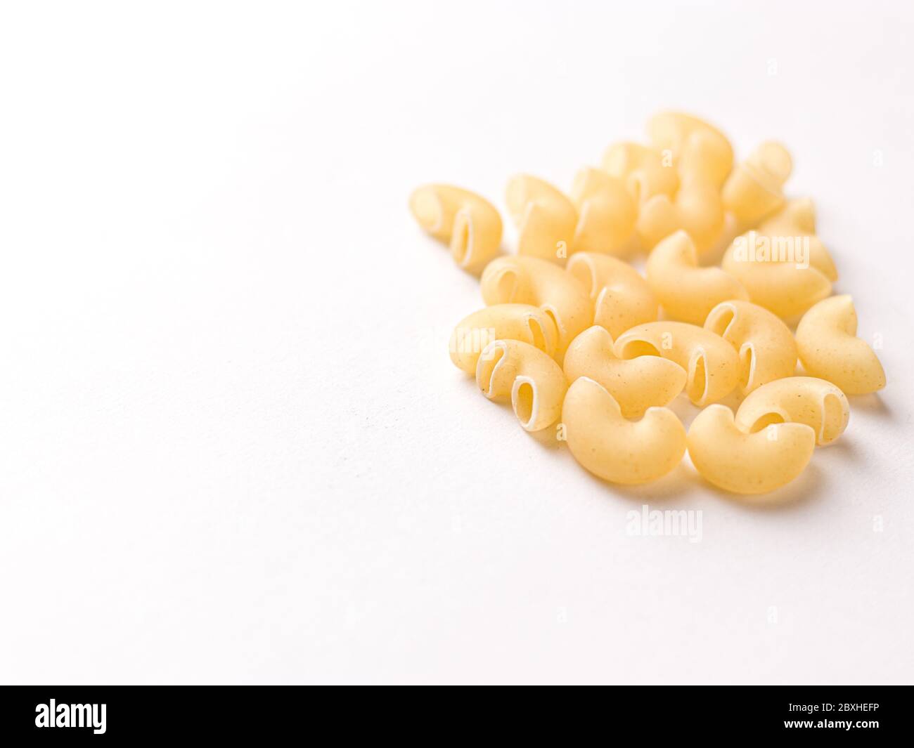 Uncooked macaroni elbow shape pasta with white background stock image ...