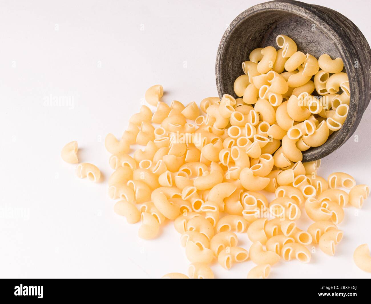 Uncooked macaroni elbow shape pasta with white background stock image ...