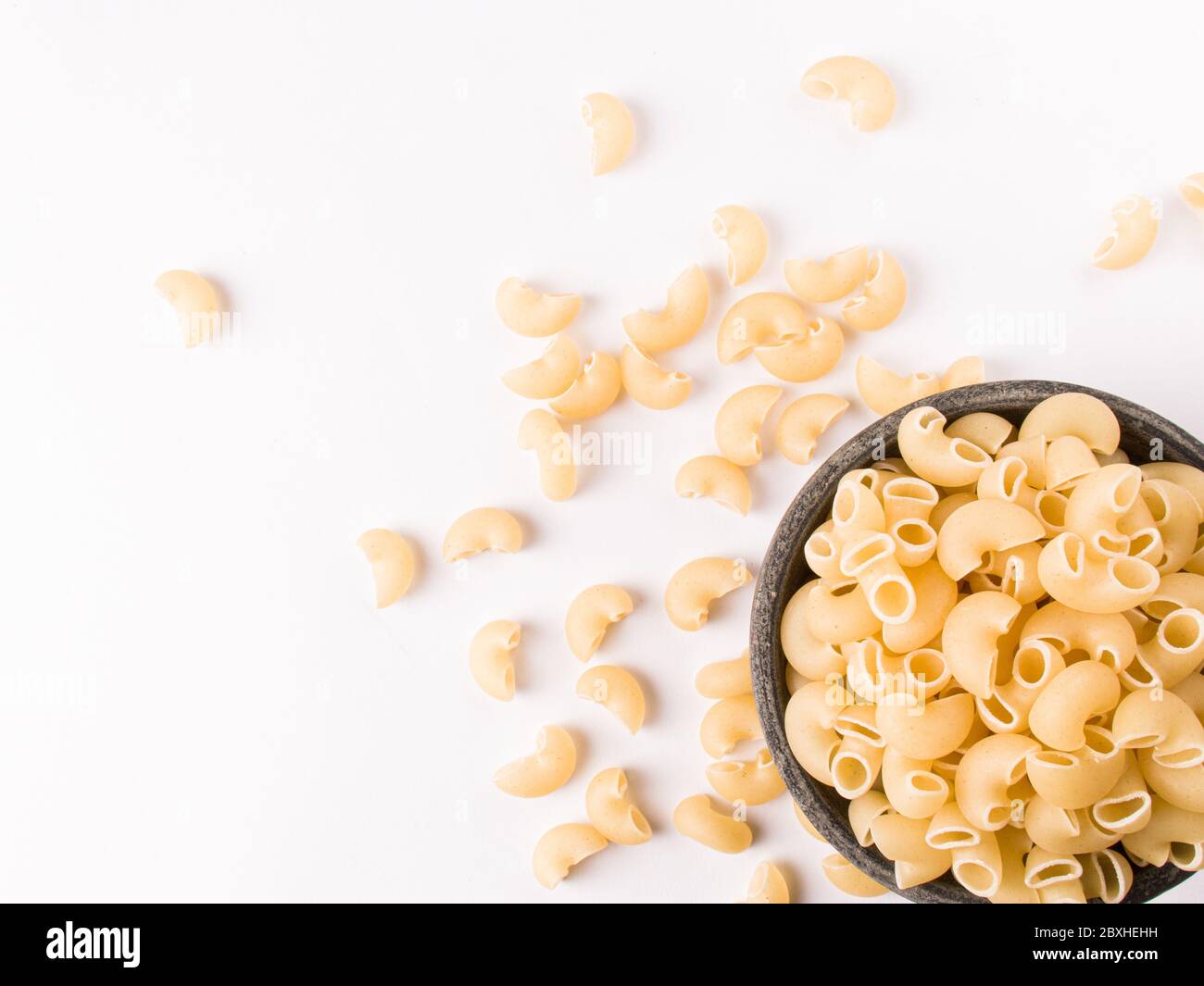 Uncooked macaroni elbow shape pasta with white background stock image ...