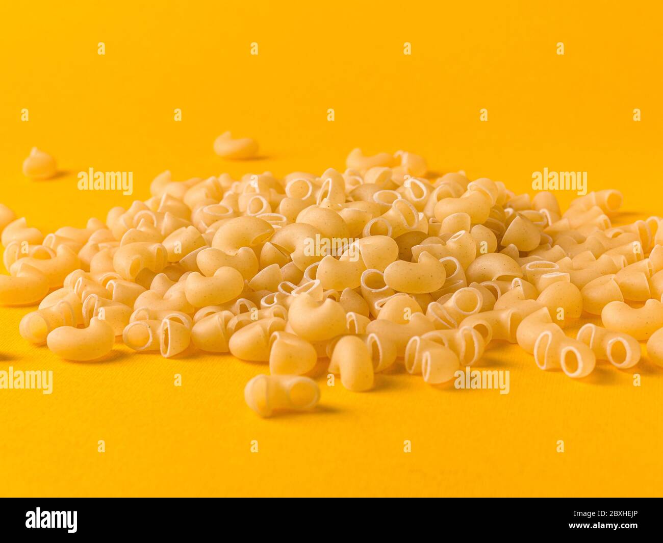 Uncooked macaroni elbow shape pasta with white background stock image ...