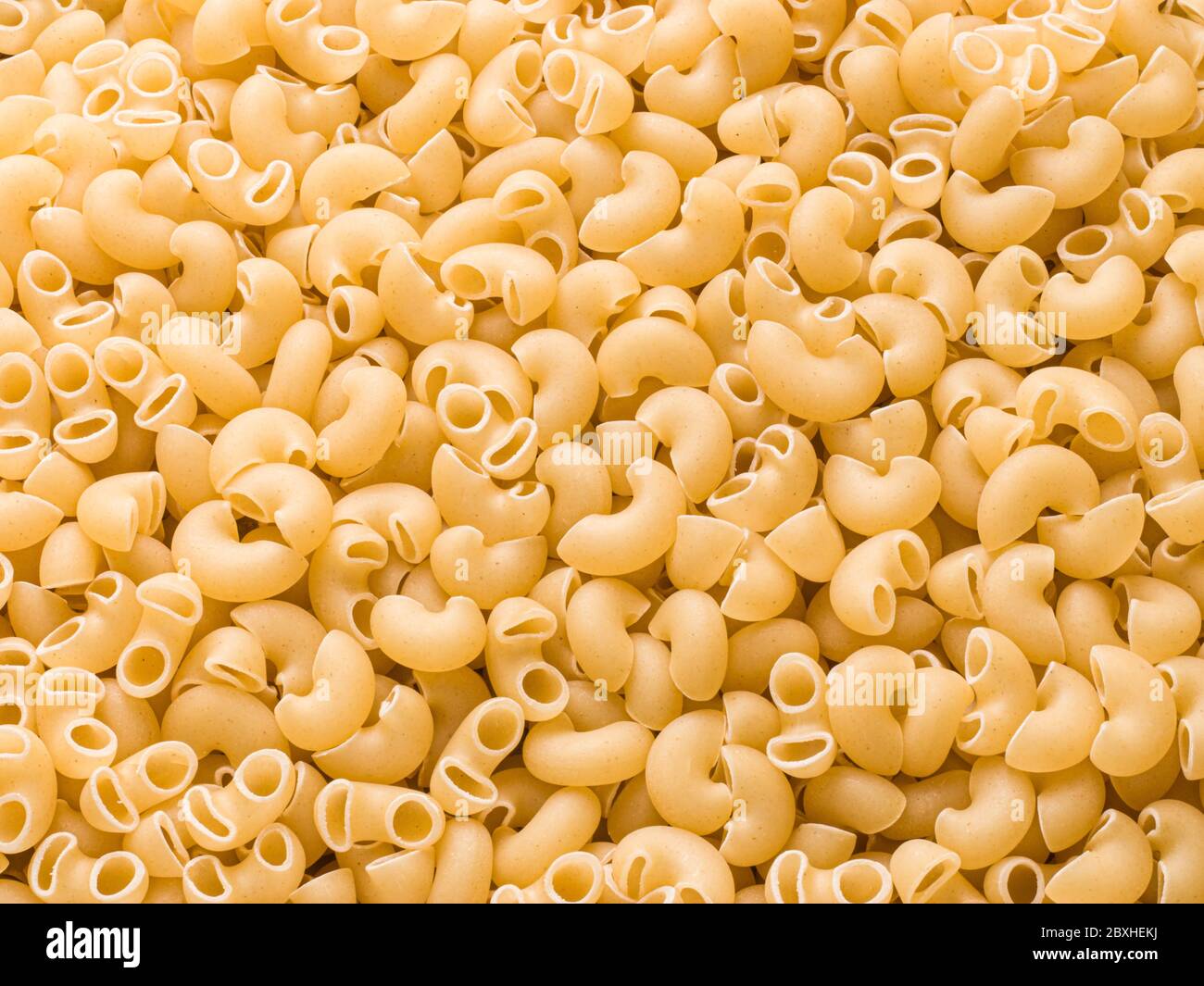 Uncooked macaroni elbow shape pasta with white background stock image ...