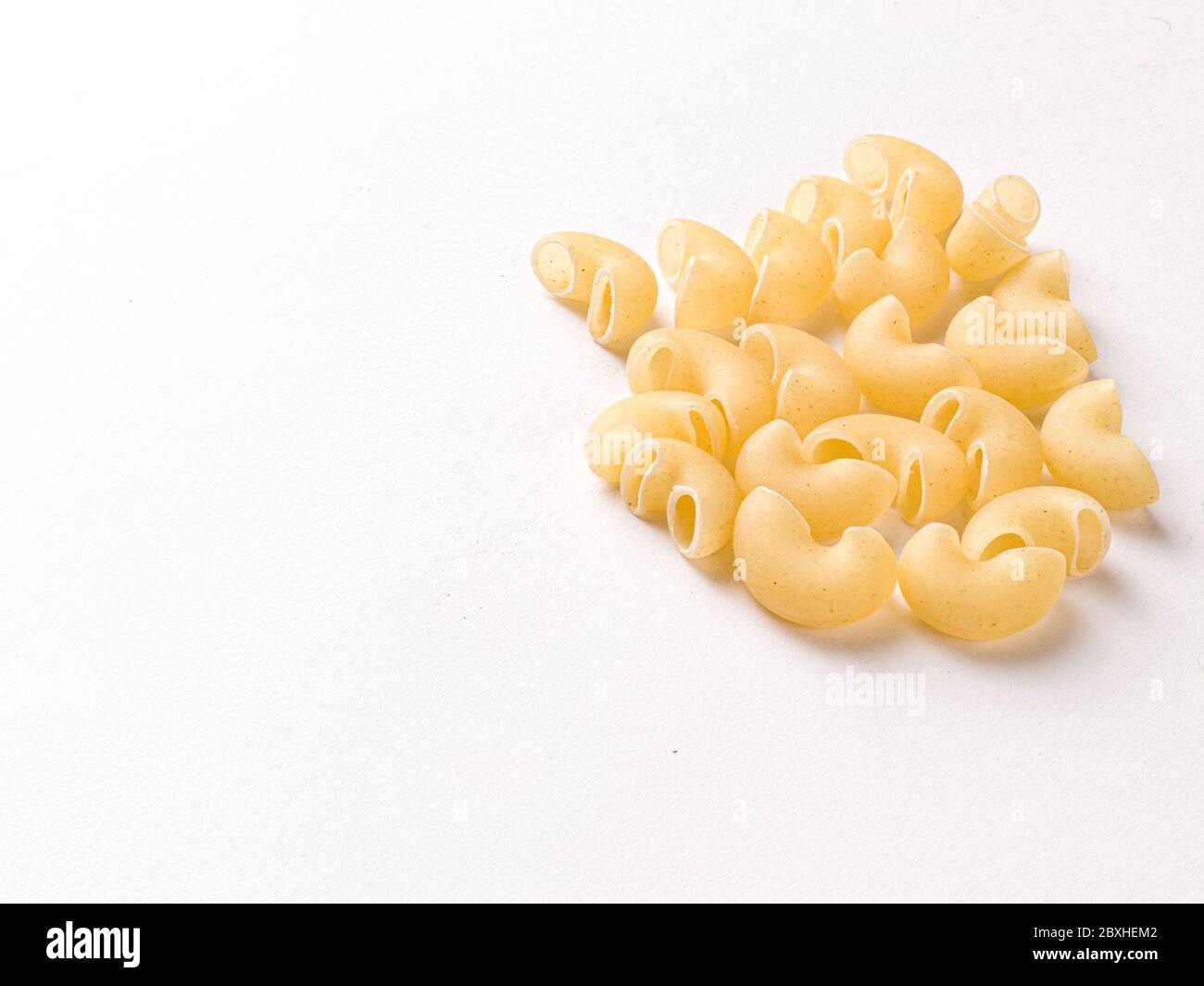 Uncooked macaroni elbow shape pasta with white background stock image ...