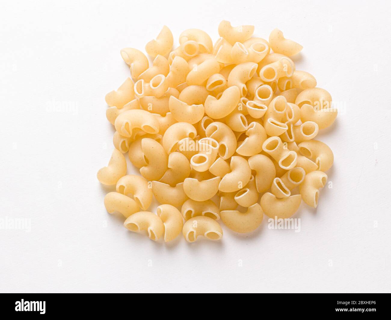 Uncooked macaroni elbow shape pasta with white background stock image ...