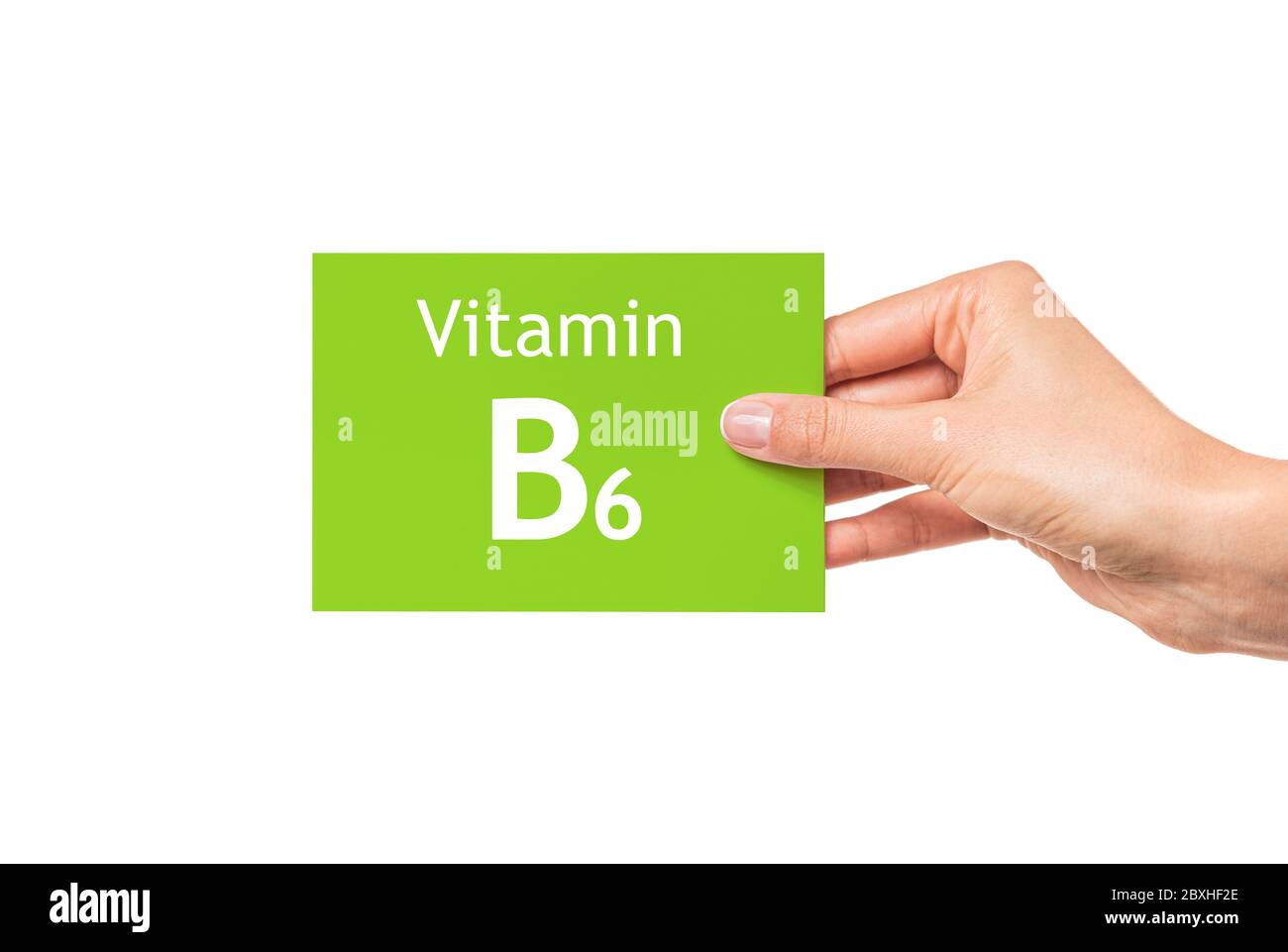 Female hand shows a card with the inscription Vitamin B6. Vitamin B6 ...