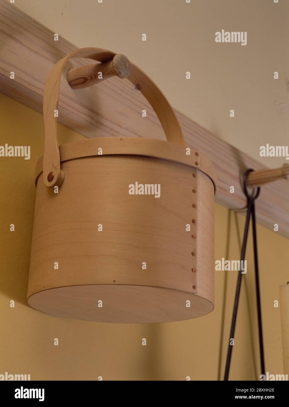 Shaker style wooden hatbox hanging on shaker hook unit Stock Photo - Alamy