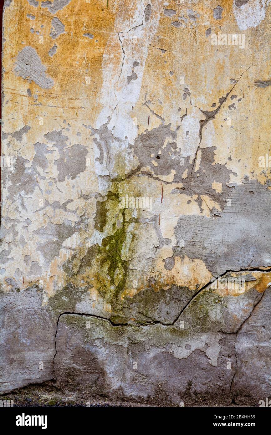 Damaged distressed concrete wall with large cracks. Texture of old ...