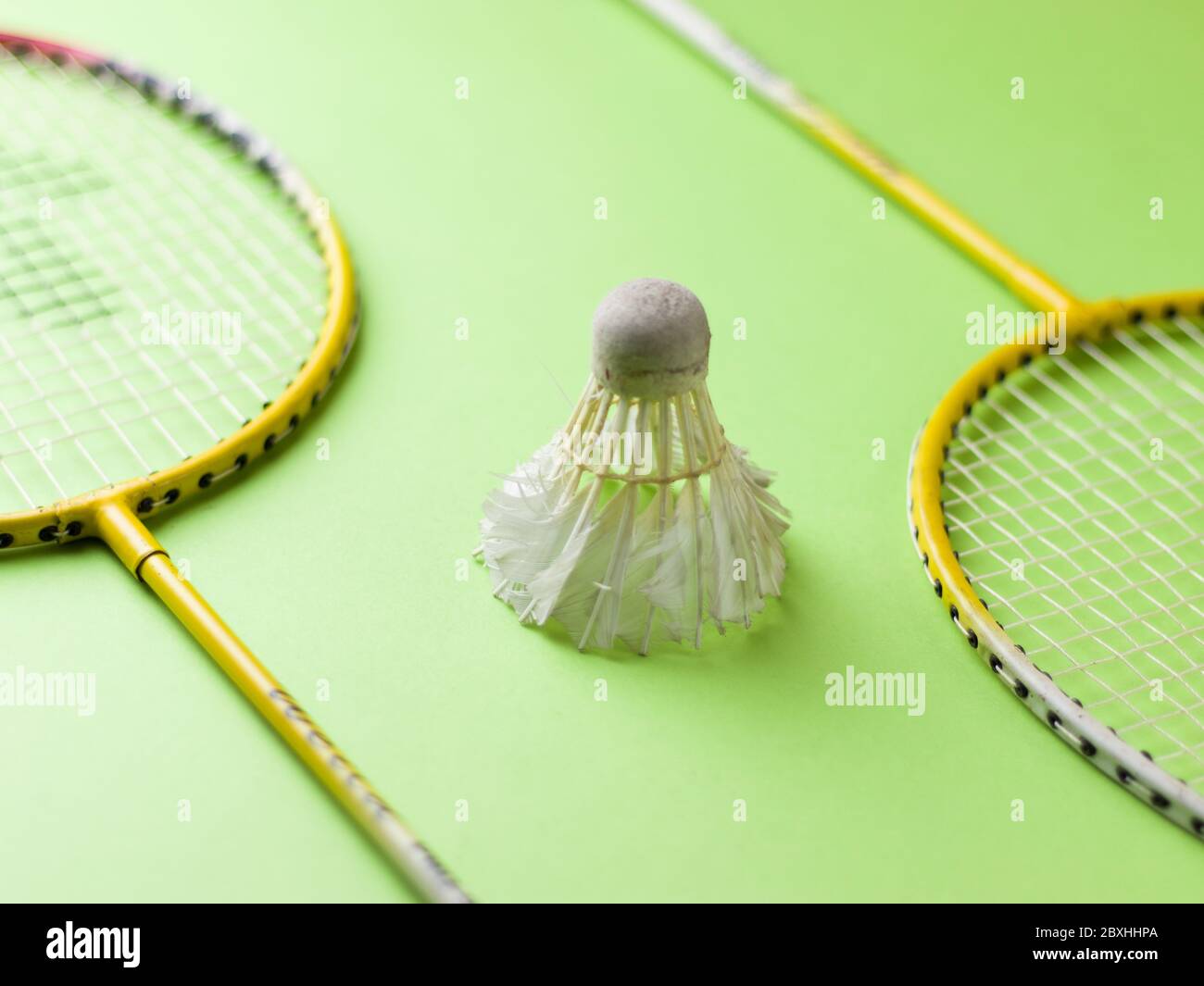 Badminton racket and White Feather Shuttlecock with a colour green ...