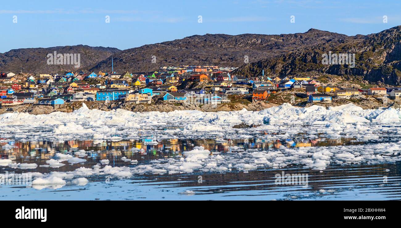 Colorful buildings of Ilulissat sit on the edge of the town's ice ...
