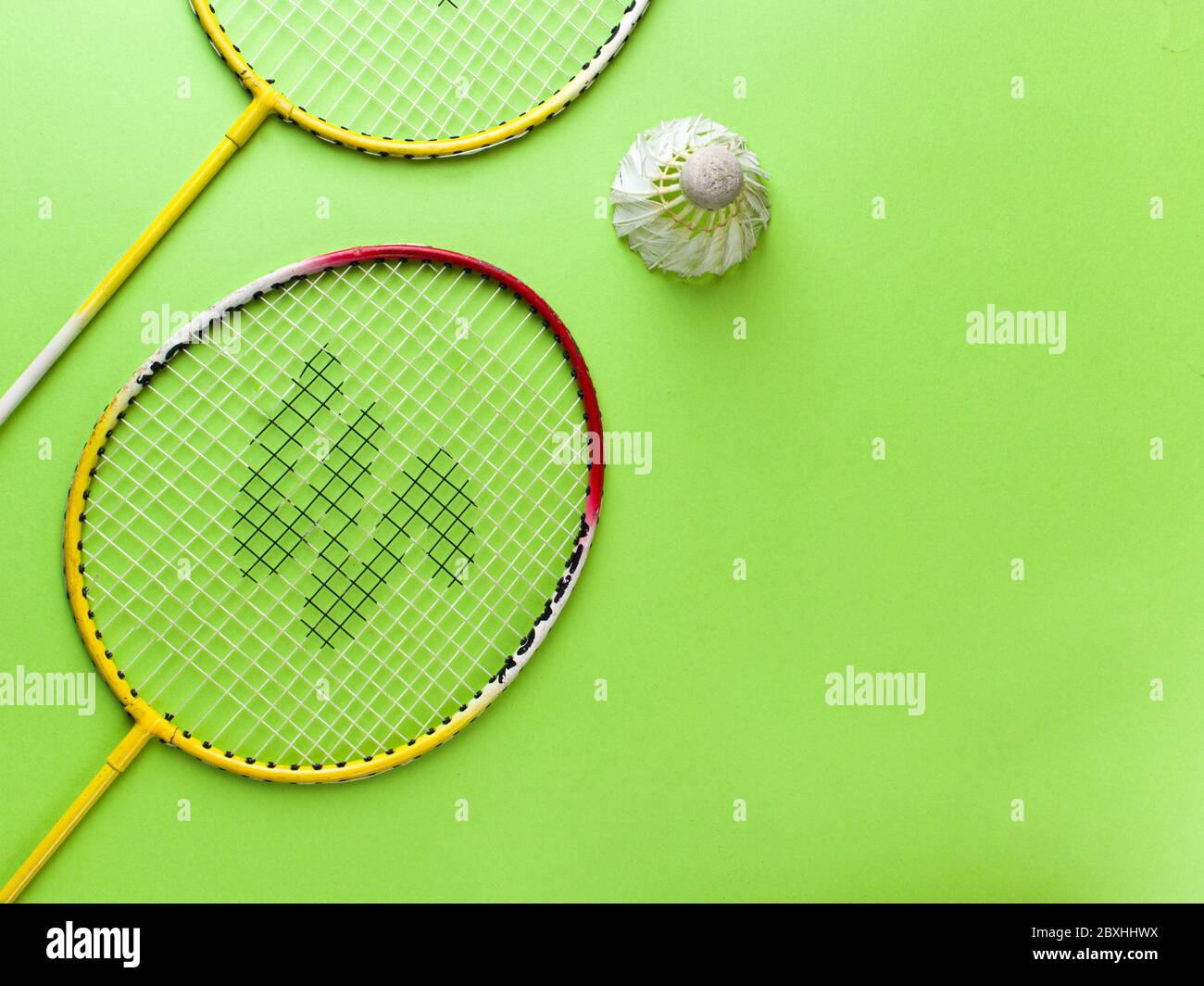 Badminton racket and White Feather Shuttlecock with a colour green ...