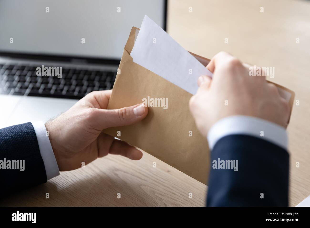 Close up male employee open envelope with letter Stock Photo - Alamy