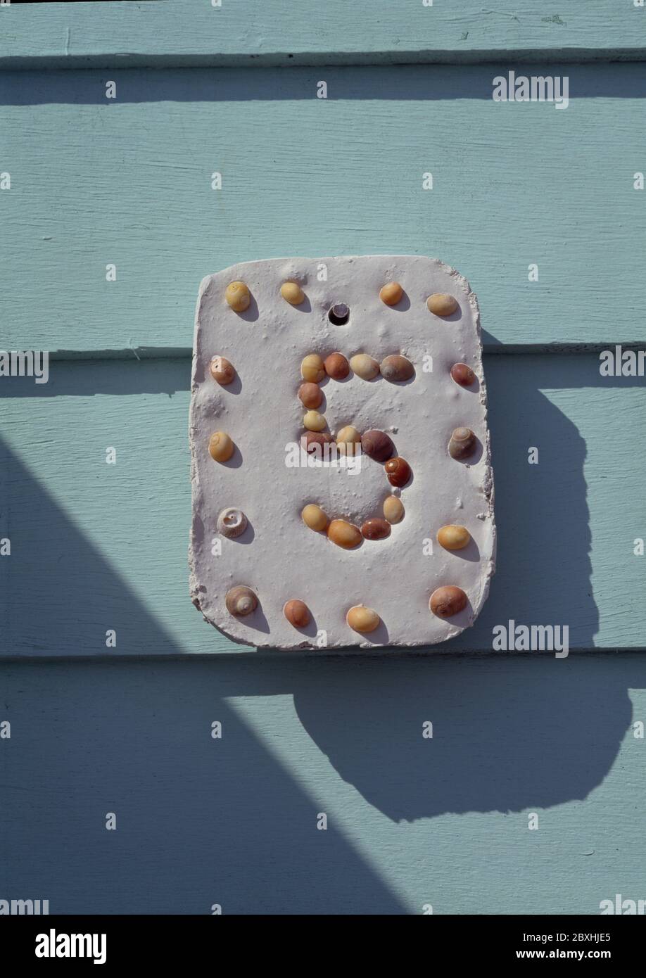 Number five on outside of beach hut Stock Photo - Alamy